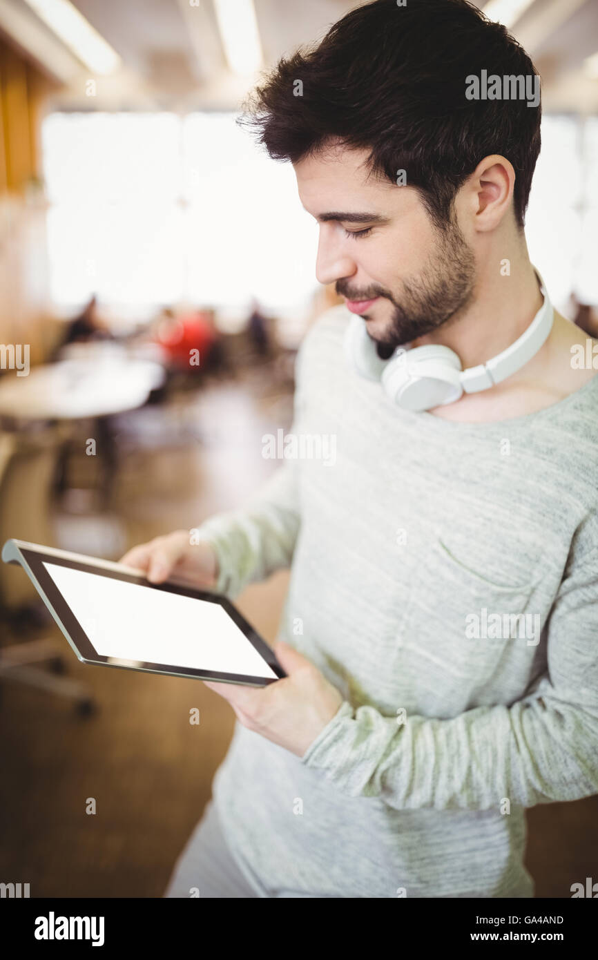Businessman holding digital tablet in office cafeteria Stock Photo - Alamy