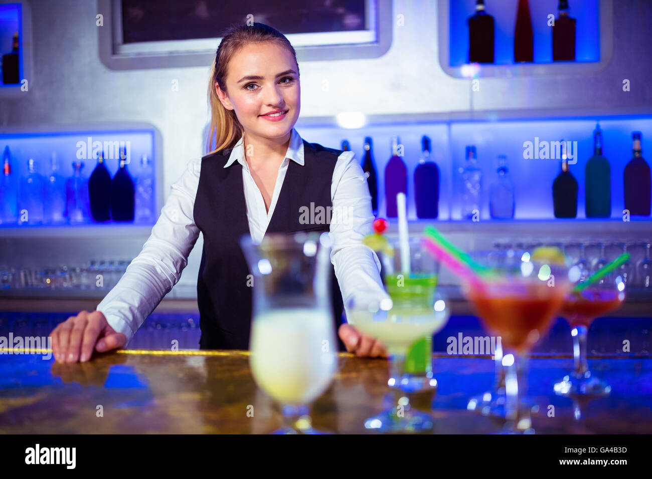 Portrait of smiling barmaid standing Stock Photo - Alamy