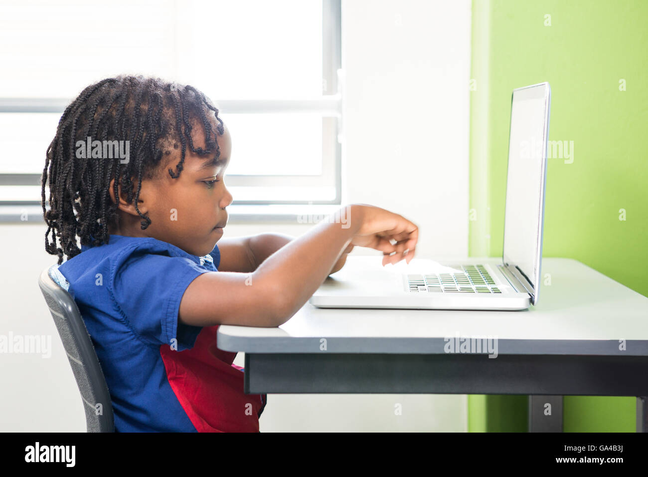 Boy using laptop in class hi-res stock photography and images - Alamy