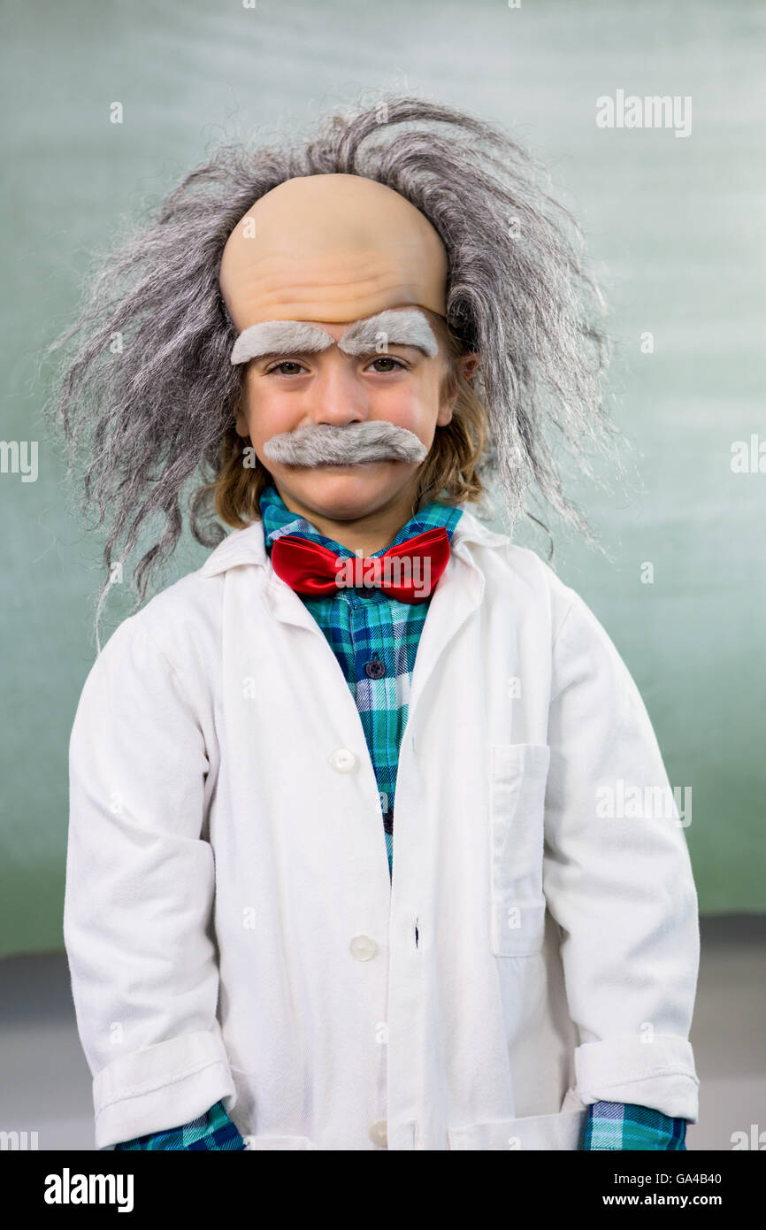 Smiling boy dressed as scientist standing against board Stock Photo - Alamy