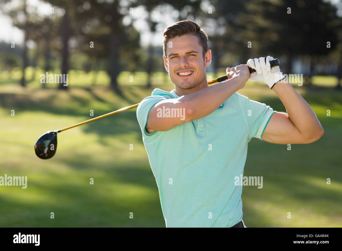 Portrait of handsome man with golf club Stock Photo - Alamy