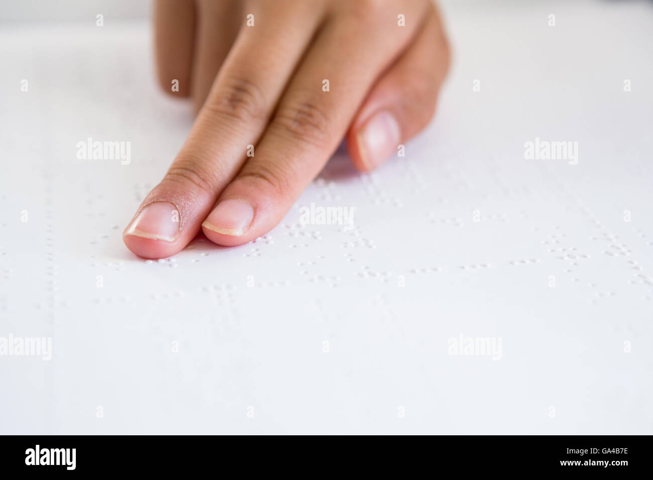 Cropped image of child hand reading braille book Stock Photo - Alamy