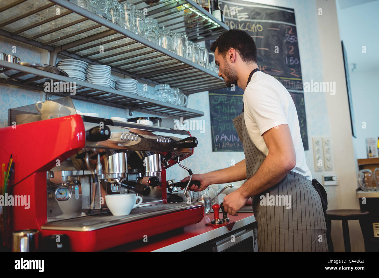 Side view of barista working by coffee maker at cafe Stock Photo - Alamy