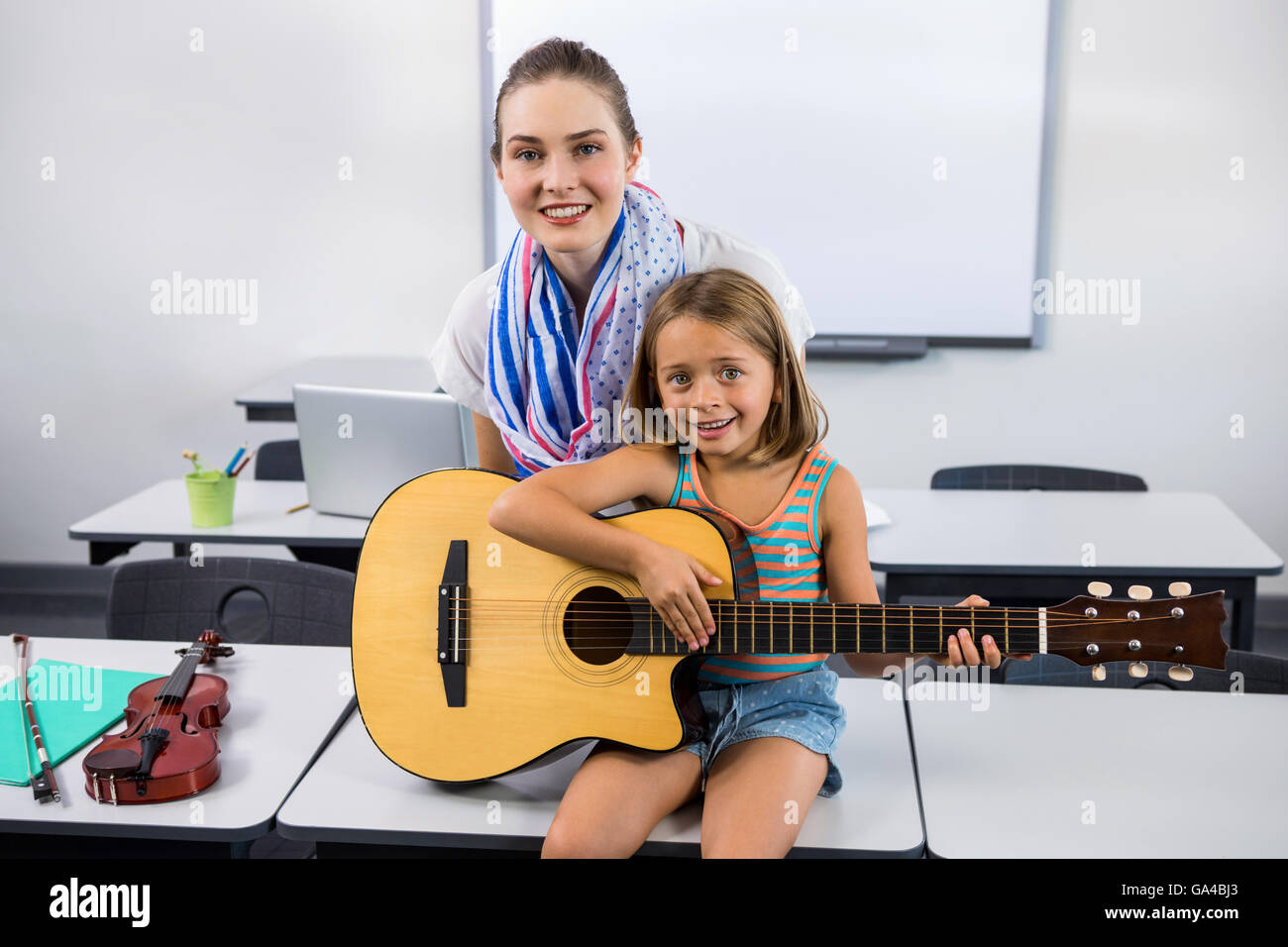 Music teacher teaching student guitar hi-res stock photography and ...