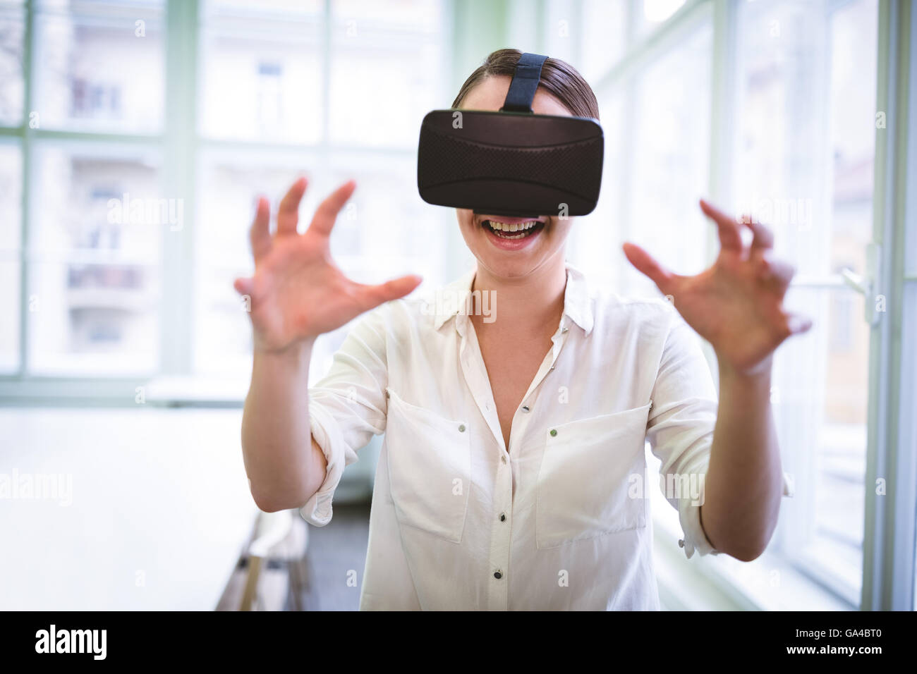 Smiling female graphic designer using virtual reality headset Stock ...