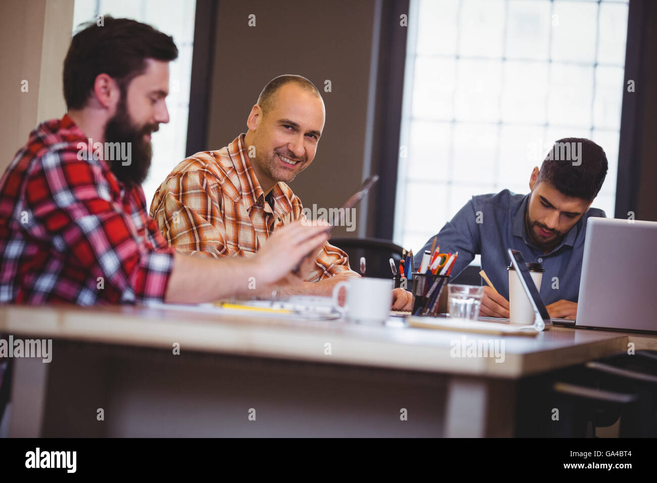Creative business people working at desk Stock Photo - Alamy