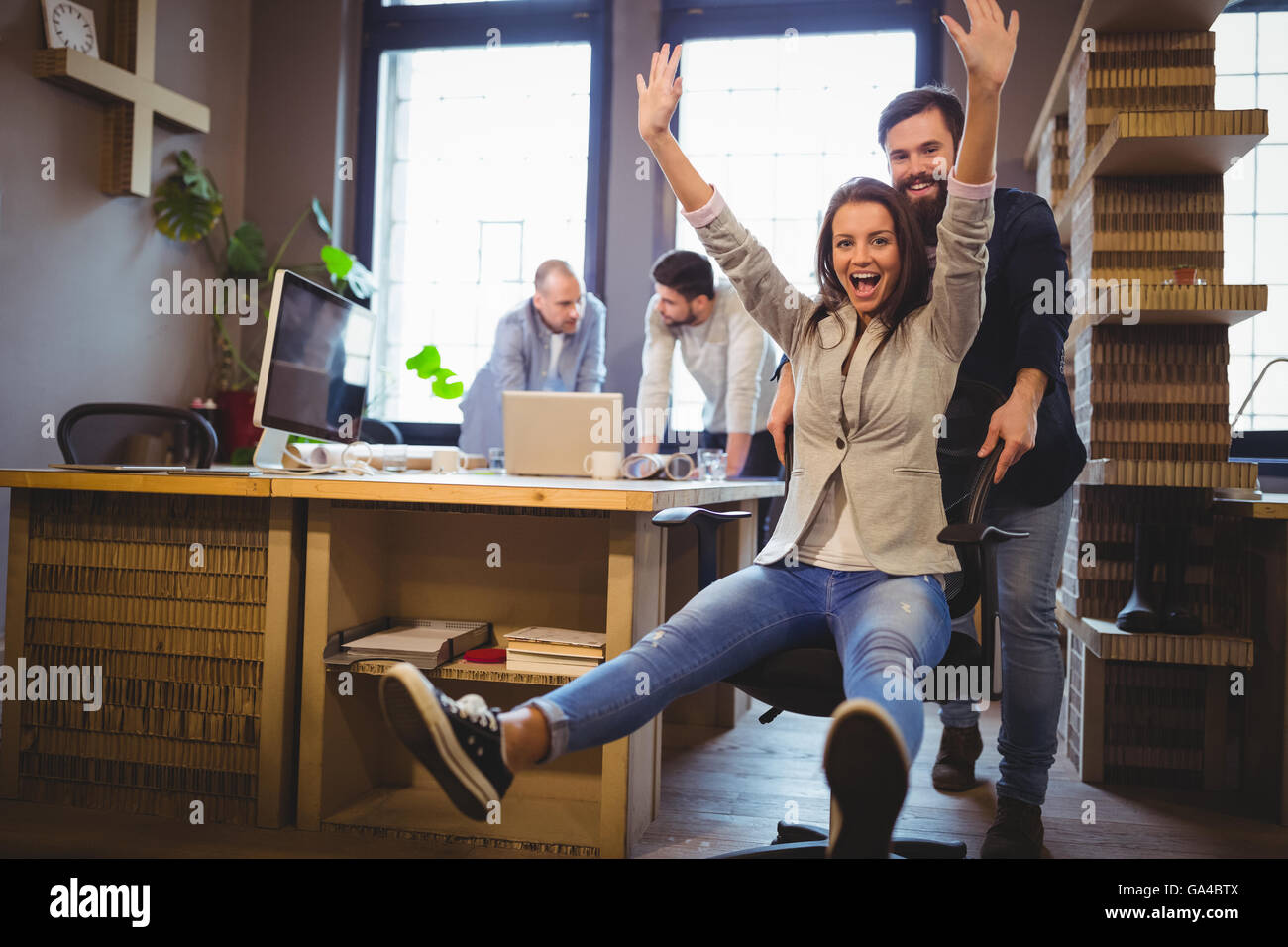 Happy coworkers enjoying in creative office Stock Photo - Alamy