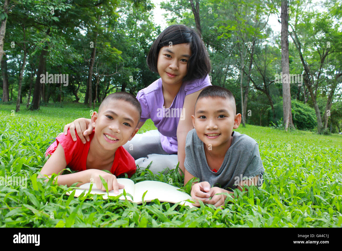 Three asian kids having a good time in the park, spring time Stock ...