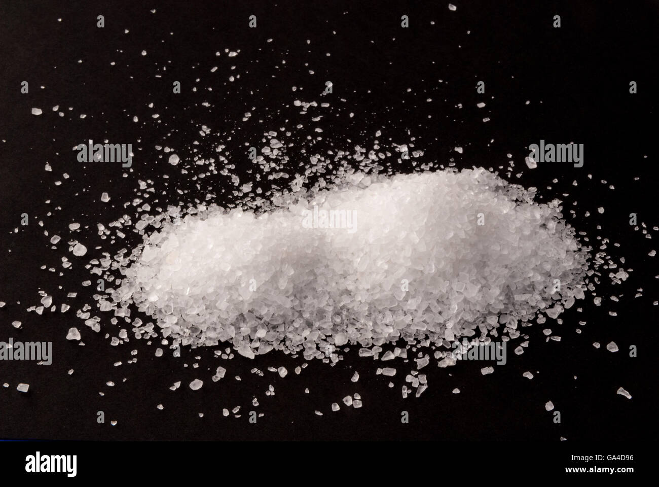 Coarse-grained sea salt from the Atlantic on black background Stock ...