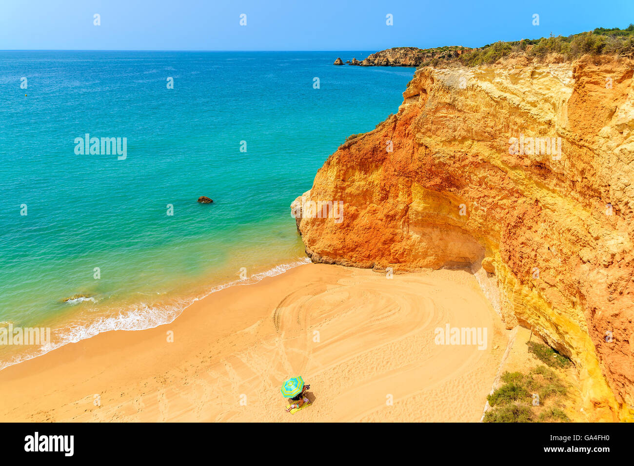 A view of a Praia da Rocha beach with golden cliffs in Portimao town ...