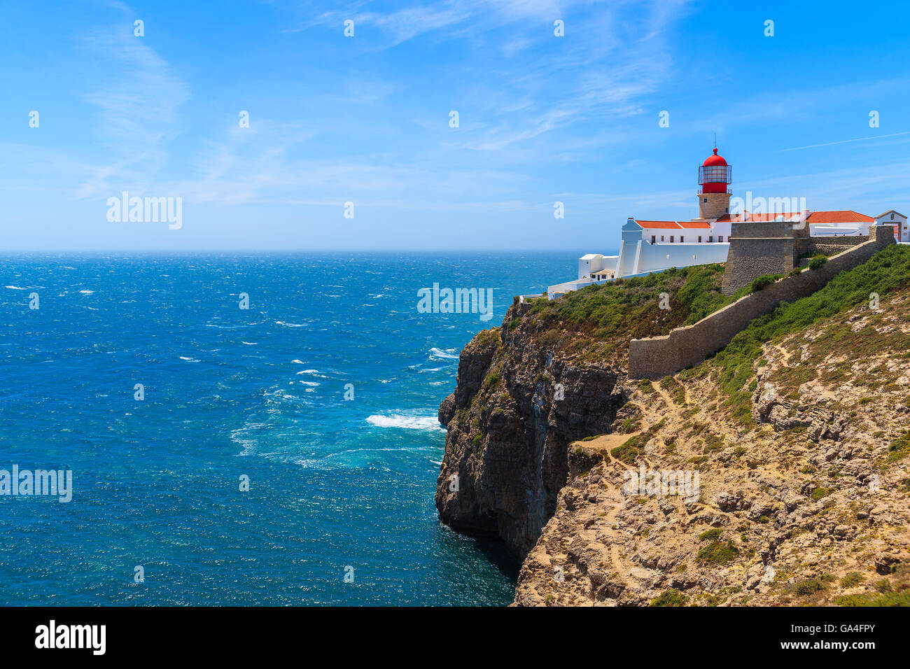 Blue sea and lighthouse on top of cliff at Cabo Sao Vicente, Algarve ...
