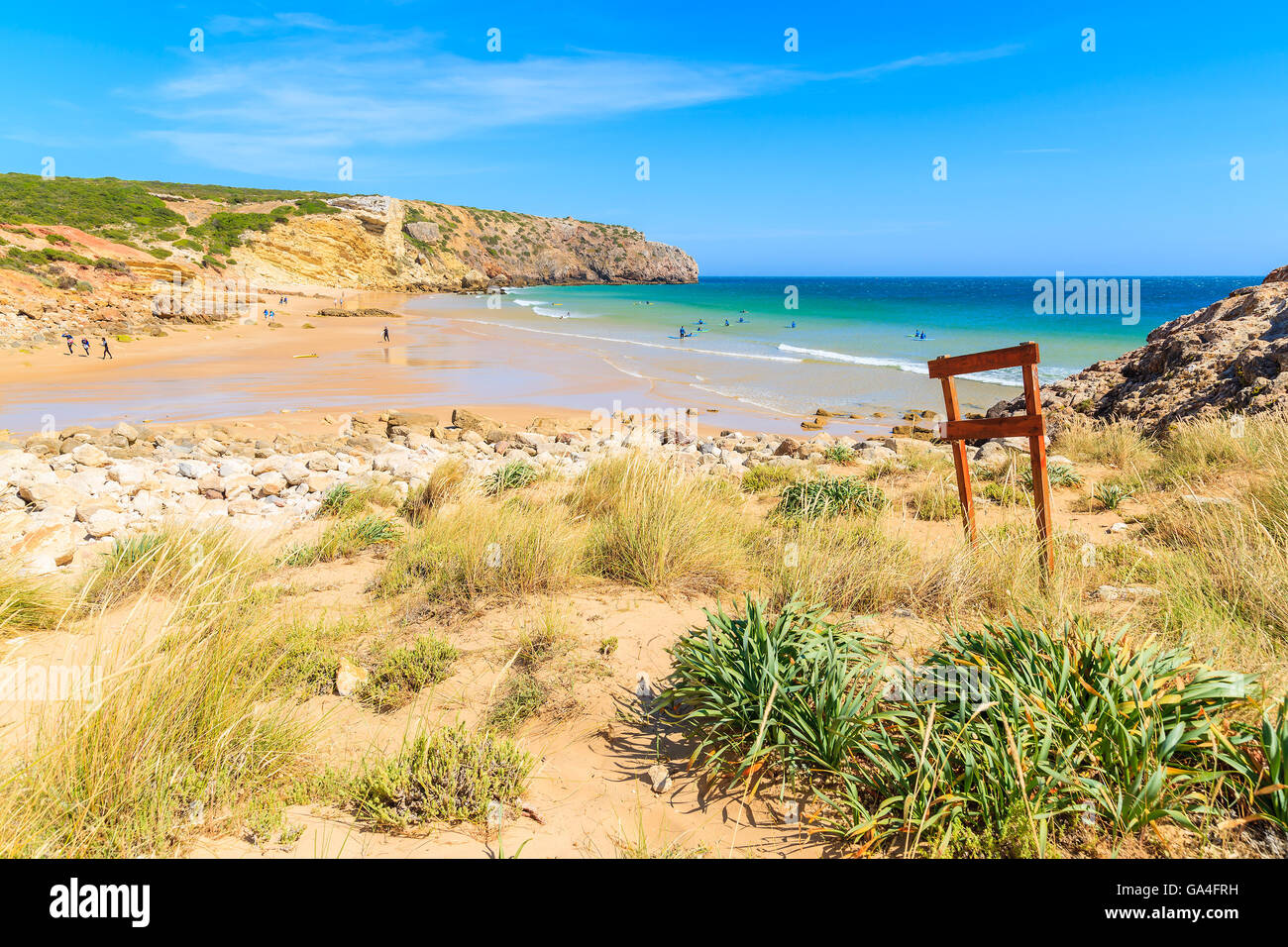 View of beautiful Zavial beach with surfers on ocean water, Portugal ...