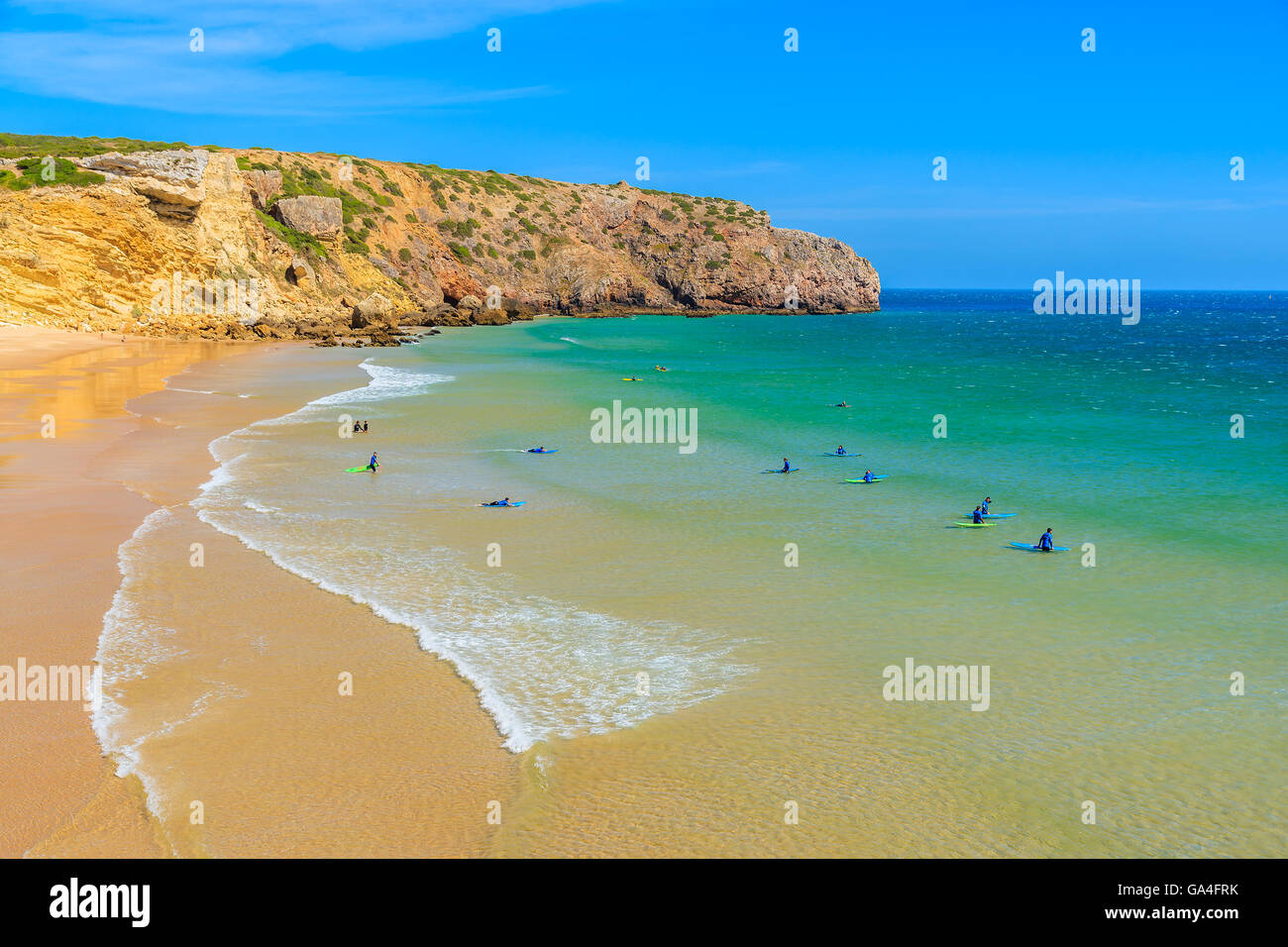 Surfers on Praia do Zavial beach with turquoise sea water, Algarve ...