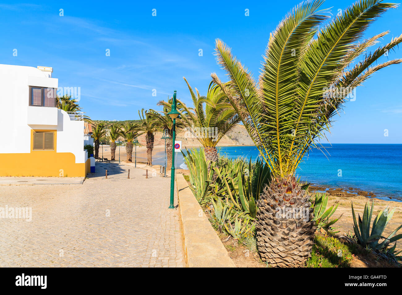 Coastal promenade with palm trees in Luz town, Algarve region, Portugal ...