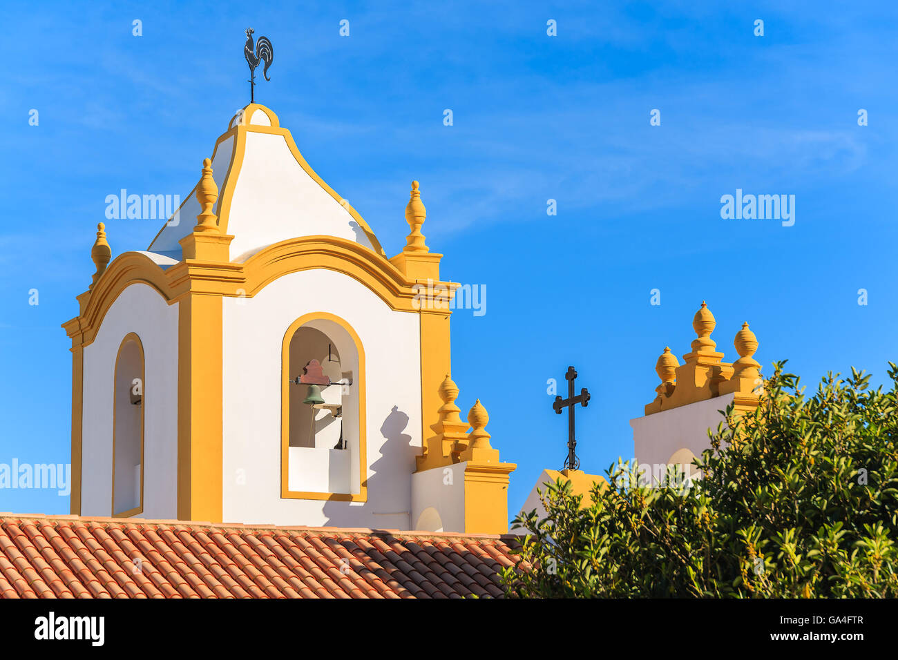 Tower of typical church in Luz town on coast of Algarve region ...