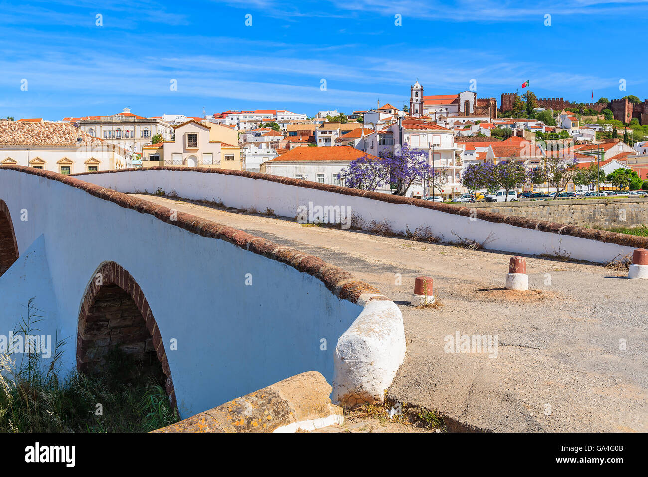 Old bridge in Silves town with view of famous castle and cathedral ...