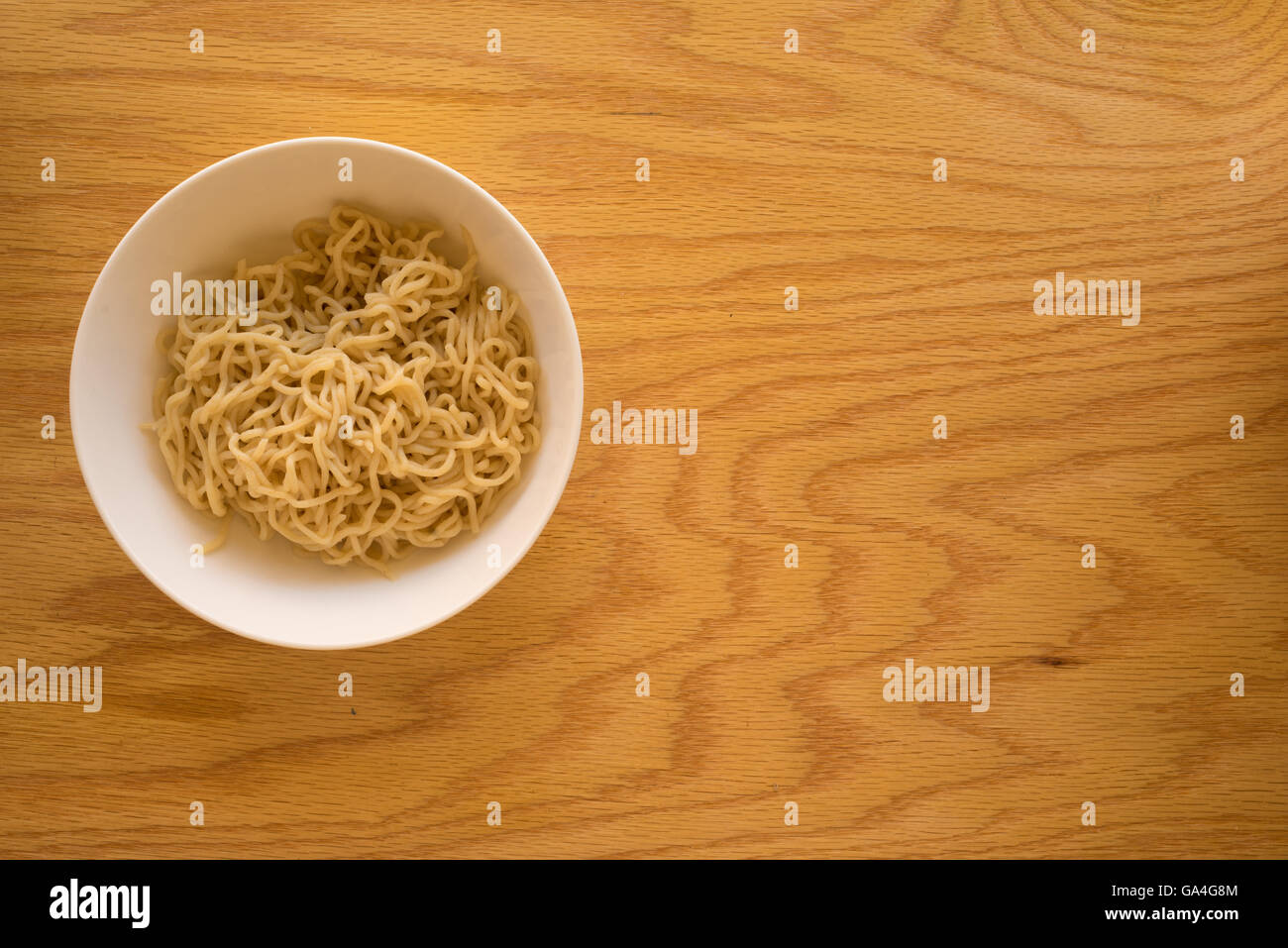 Bowl of Noodles on Wood Table Stock Photo - Alamy