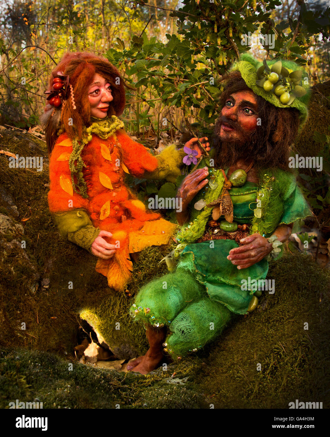 two fairy tale dwarf figures sitting on moos in woodland Stock Photo ...