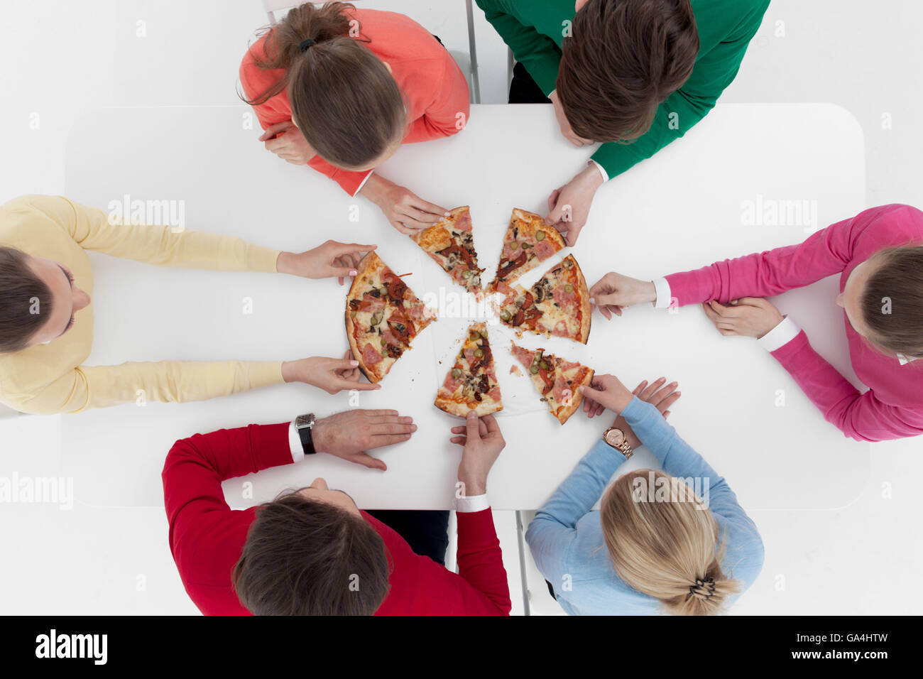 Top view of people sitting around the table with pizza Stock Photo - Alamy