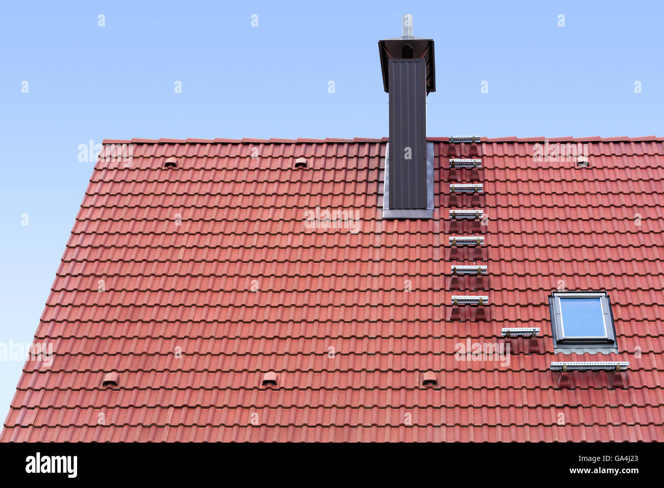 Roof View - skylight, ladder and chimney Stock Photo - Alamy