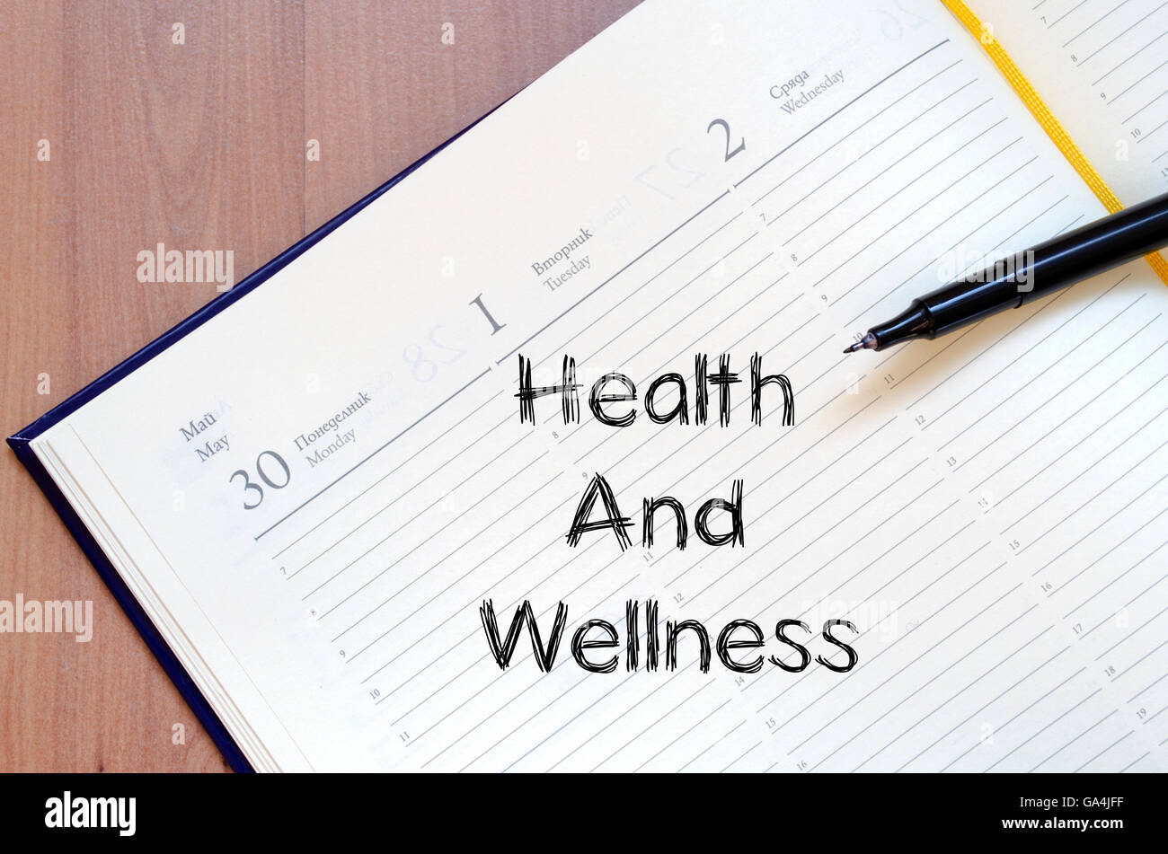 Health and wellness text concept write on notebook Stock Photo - Alamy
