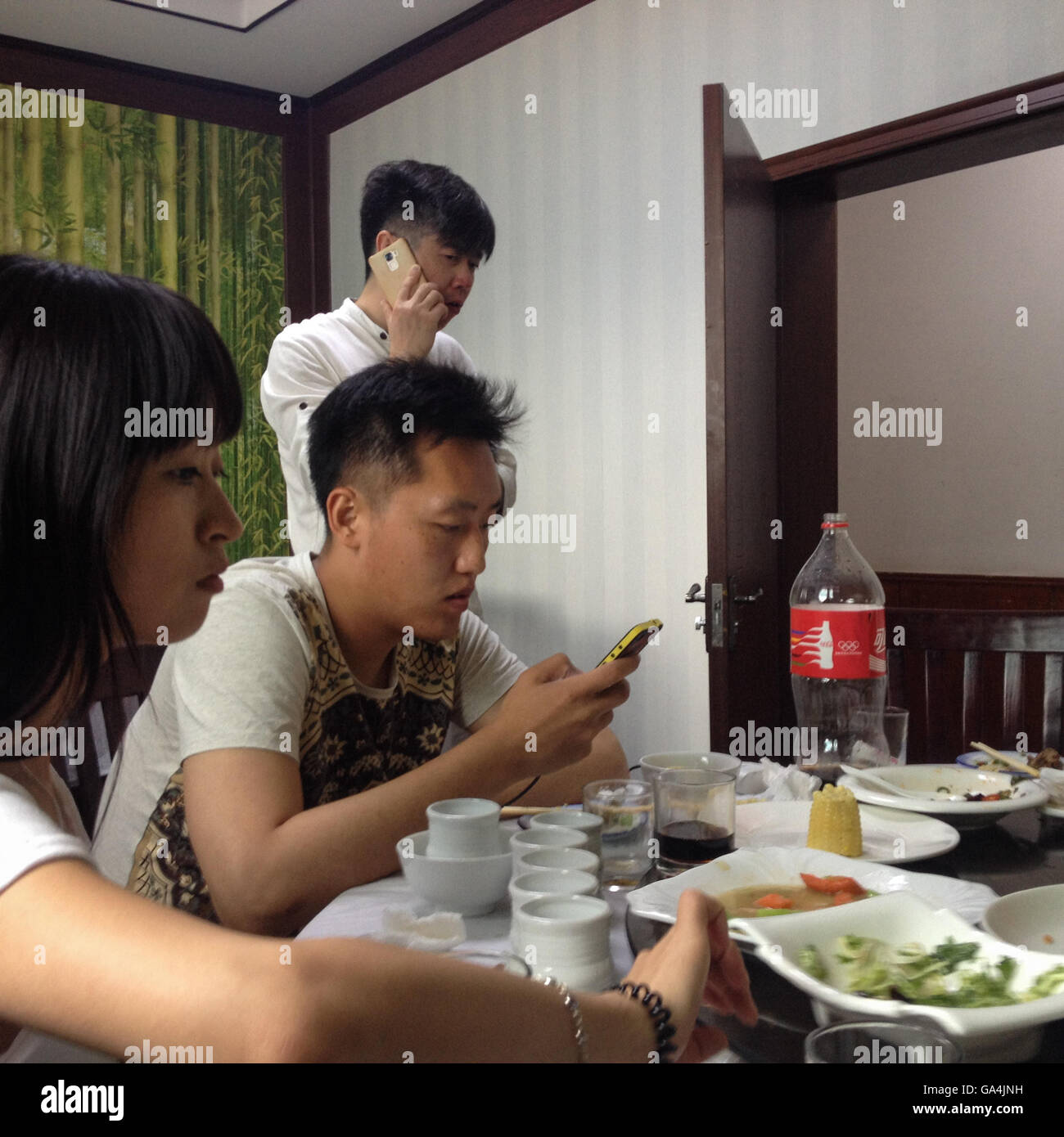 Chinese youths play with their smartphones and social media, after a ...