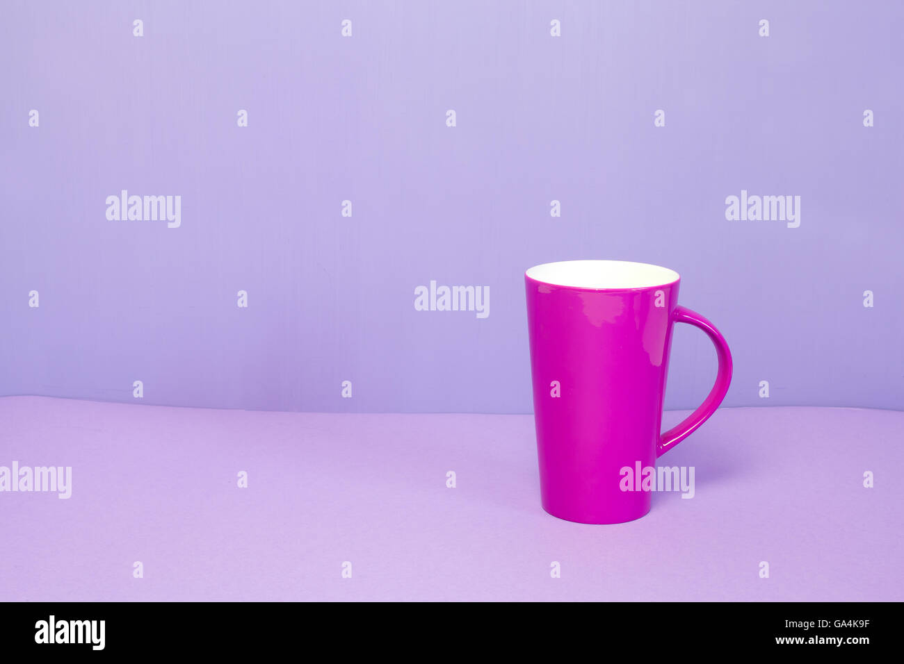 Simple purple mug on a lilac background Stock Photo - Alamy