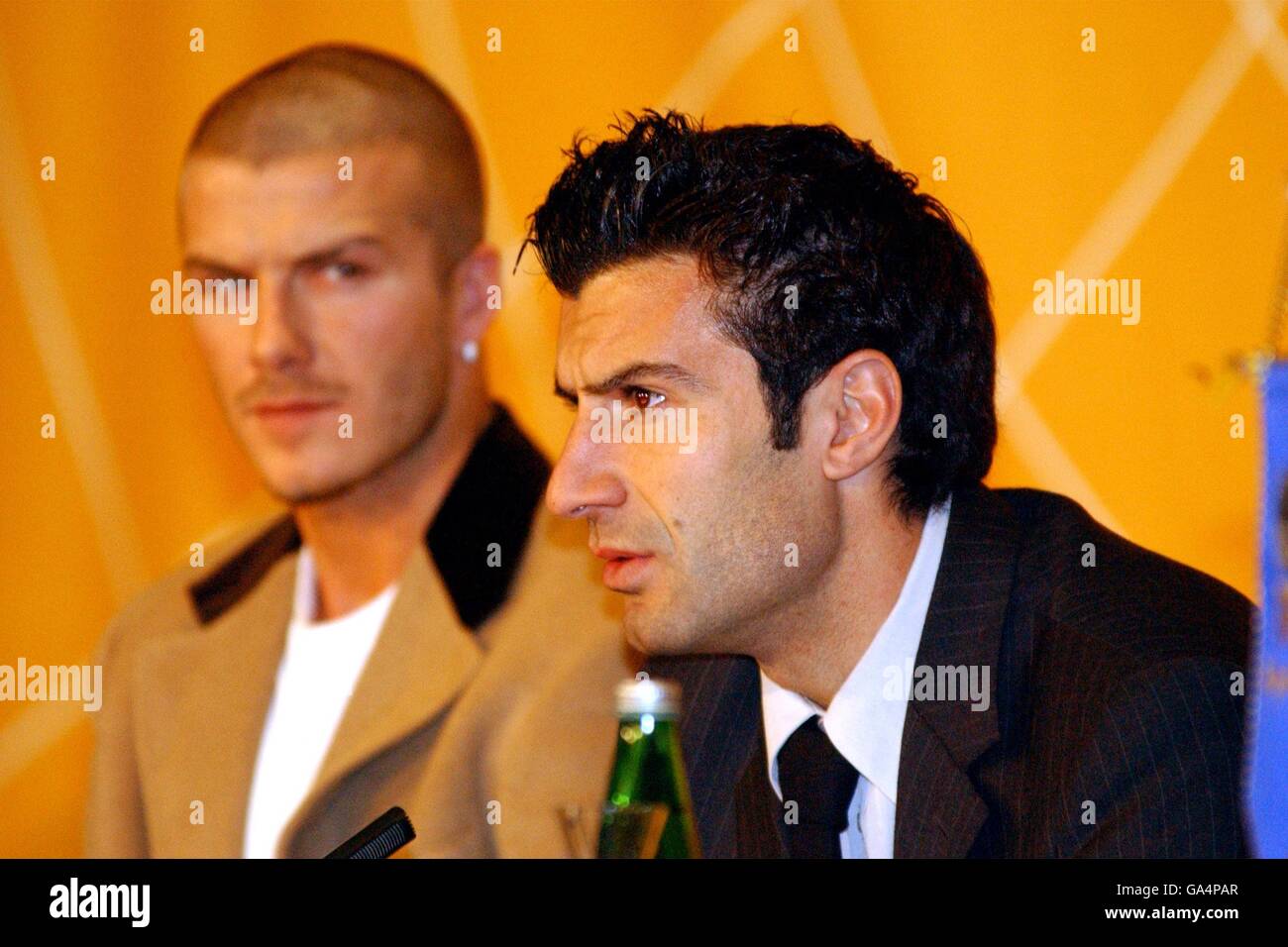 Second place David Beckham looks on as winner Luis Figo speaks at a ...
