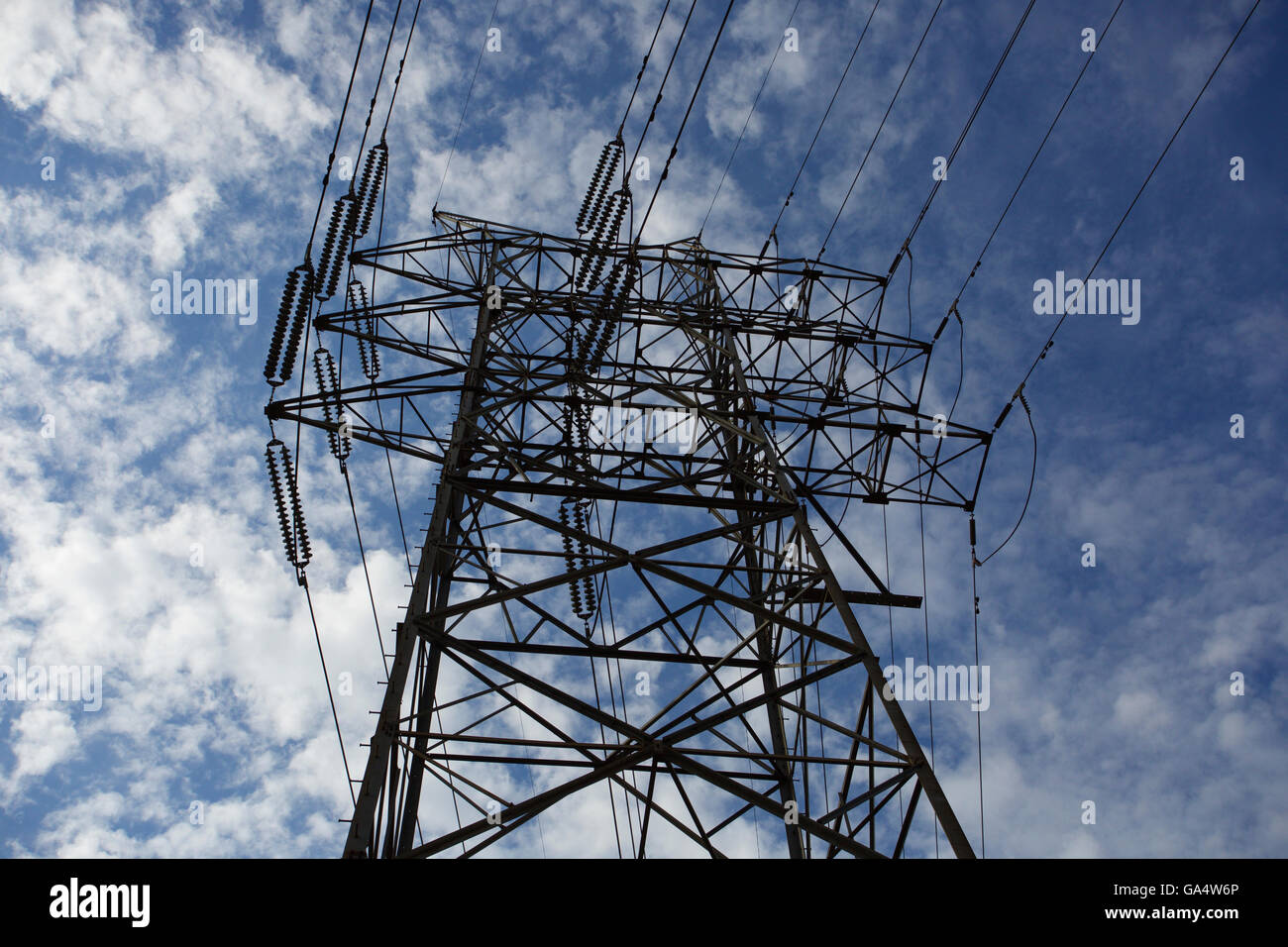 High power lines with a blue sky and clouds Stock Photo - Alamy