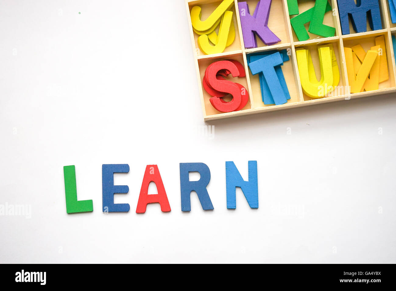 Colorful wooden letter with white background Stock Photo - Alamy