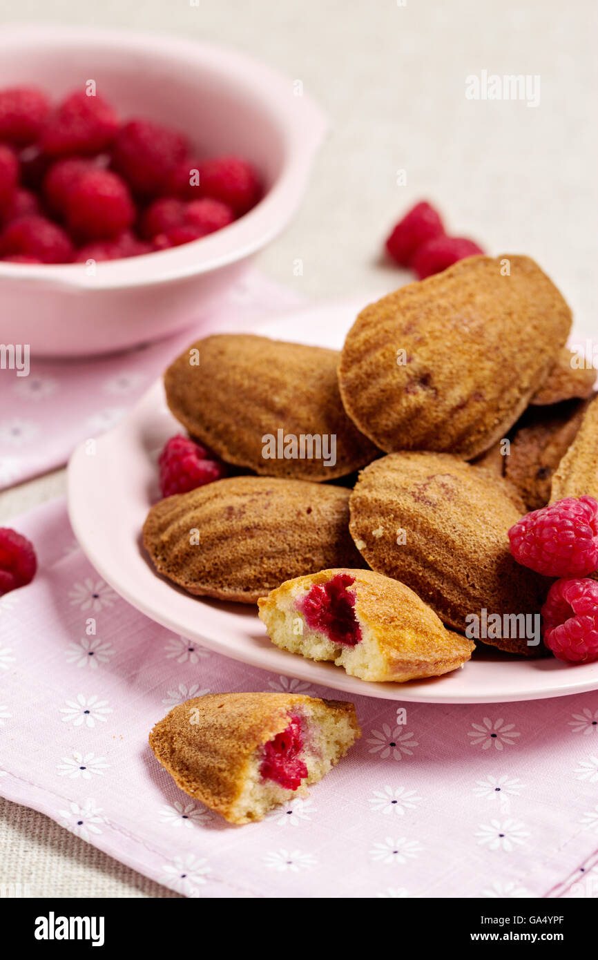 French pastry Madeleine with raspberries. Selective focus Stock Photo ...