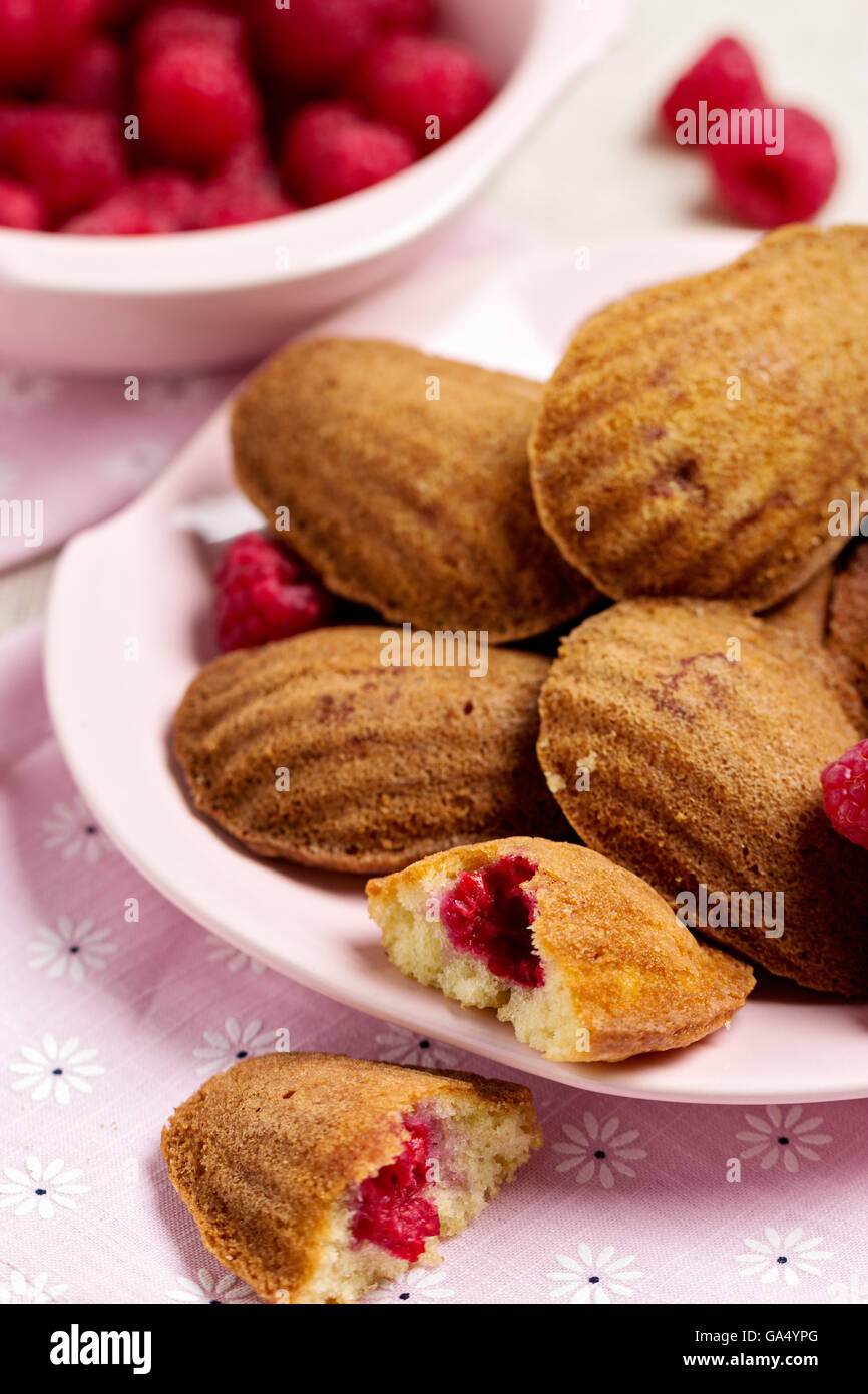 French pastry Madeleine with raspberries. Selective focus Stock Photo ...