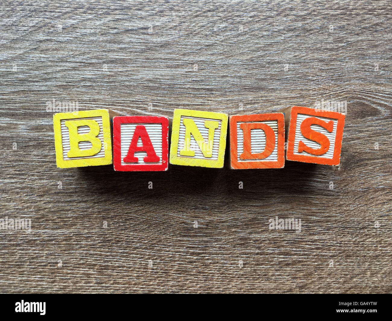 Word BANDS Done With Toy Wood Blocks Letters On A Wooden Board Stock