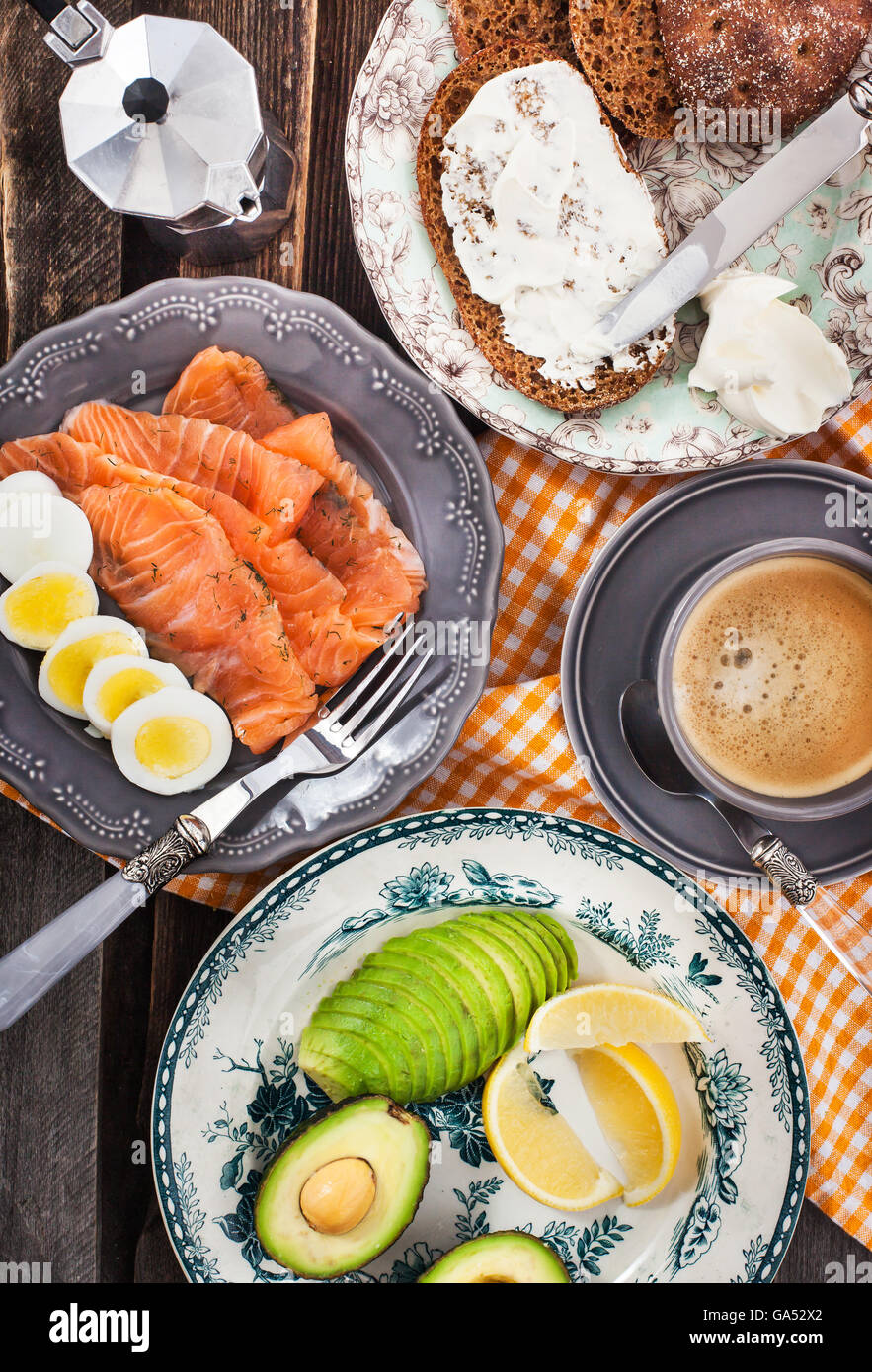 Breakfast with salted salmon, boiled eggs, avocado, bread, cream cheese ...