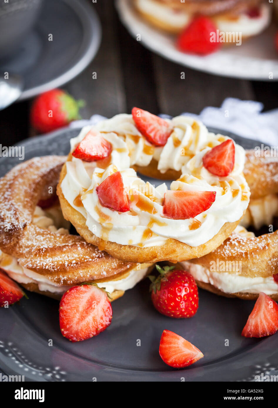 Cream puff rings (choux pastry) decorated with fresh strawberry and ...