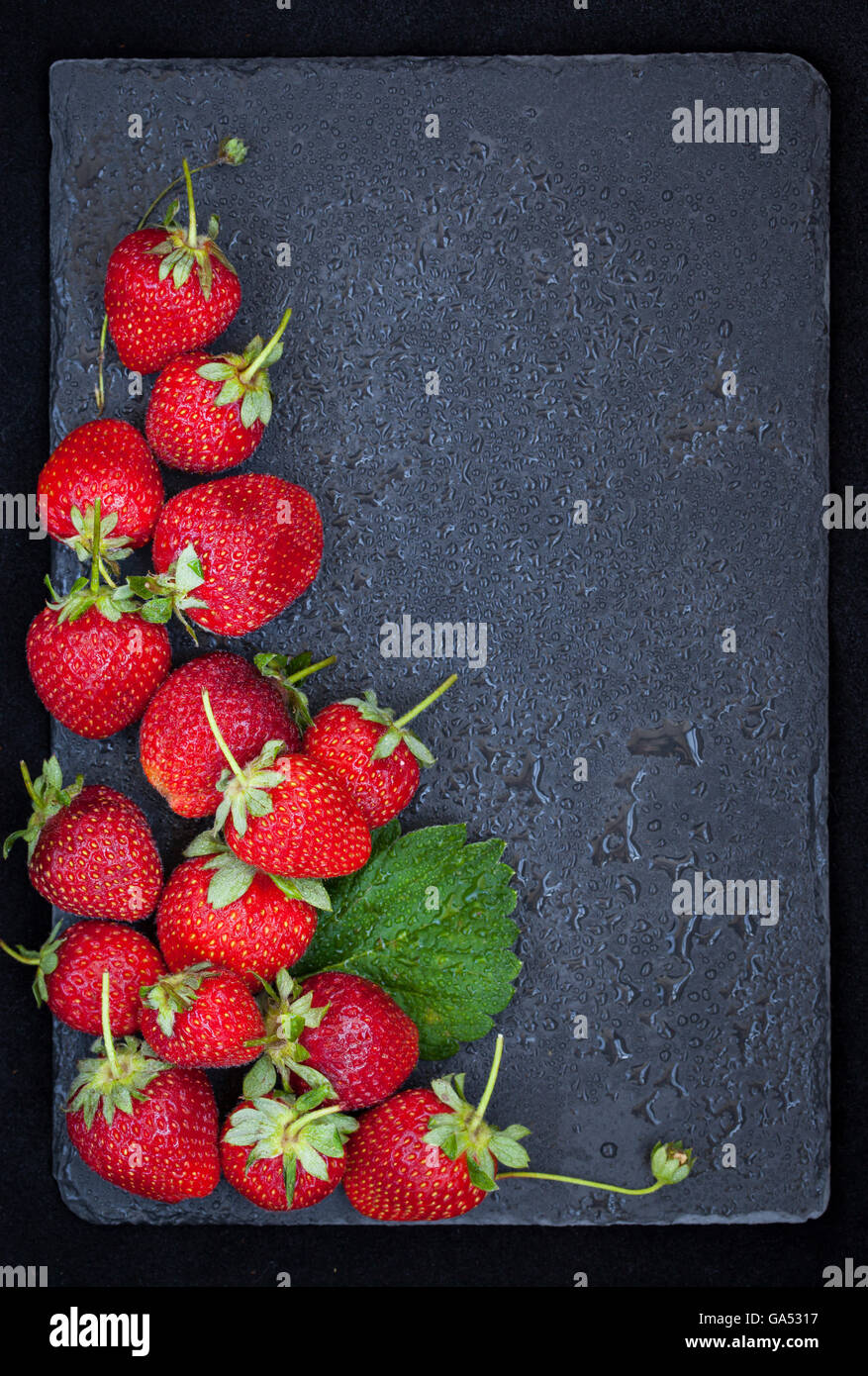 Fresh ripe strawberry on dark background with empty space (copy space ...