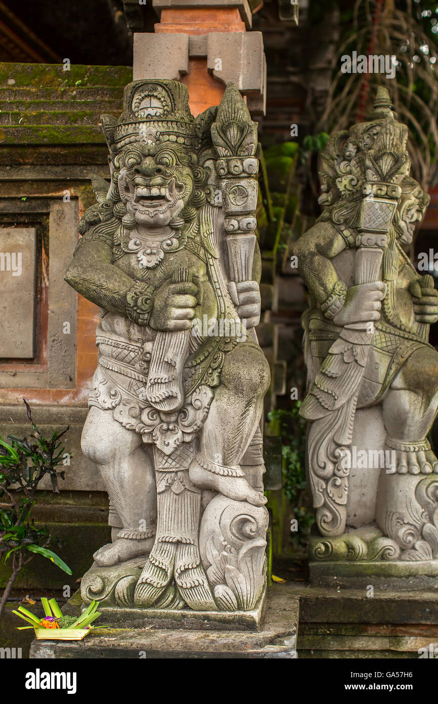 Traditional demon guards statue carved in stone in Bali Stock Photo - Alamy