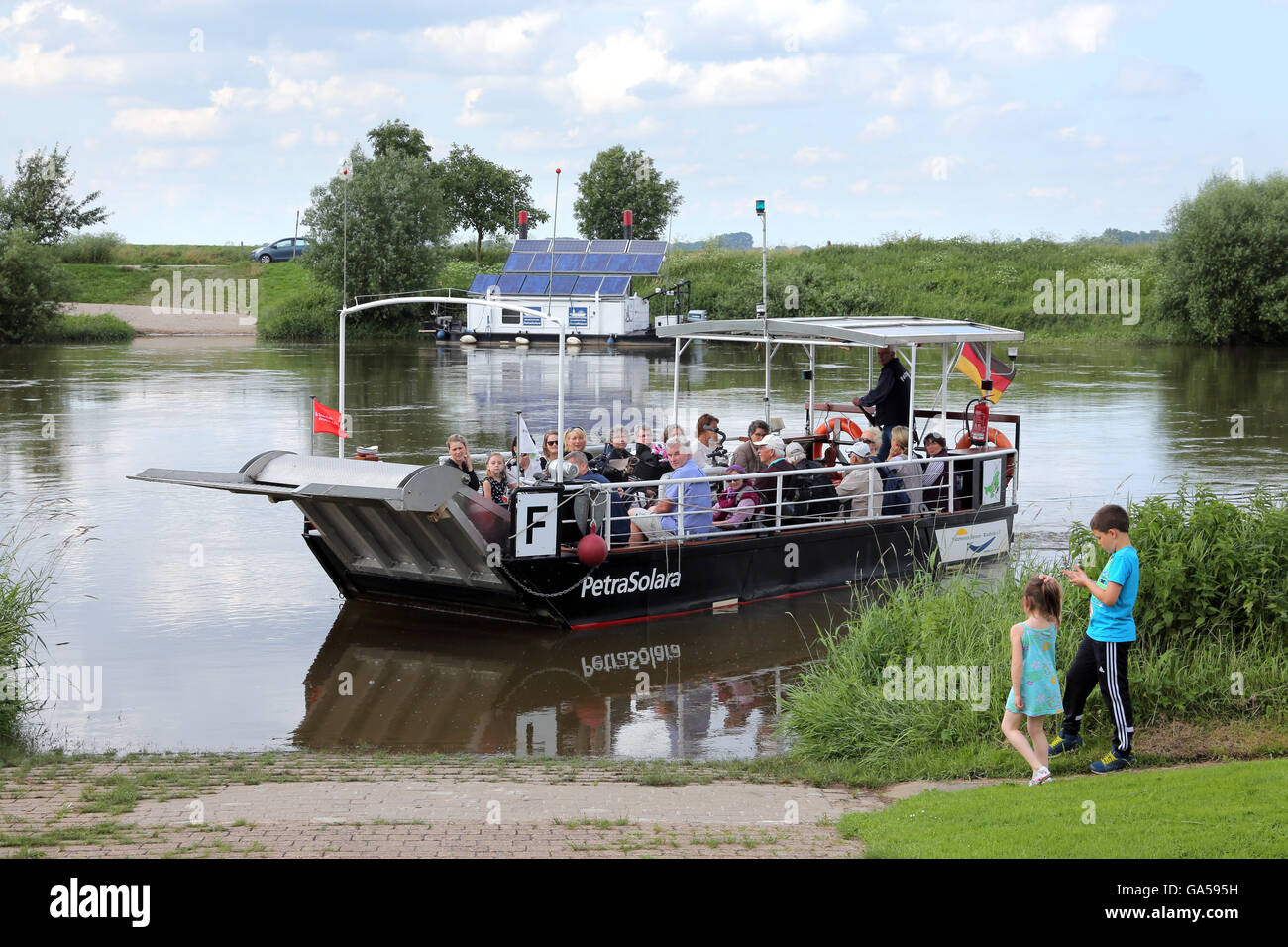 Solar powered ferry PETRA SOLARA across the river Weser near Windheim ...