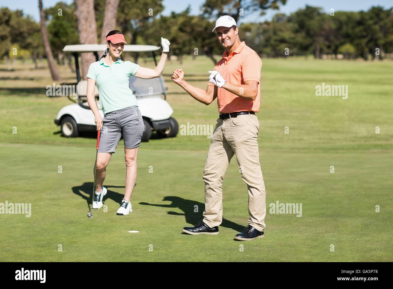 Full length portrait of golfer couple celebrating success Stock Photo ...