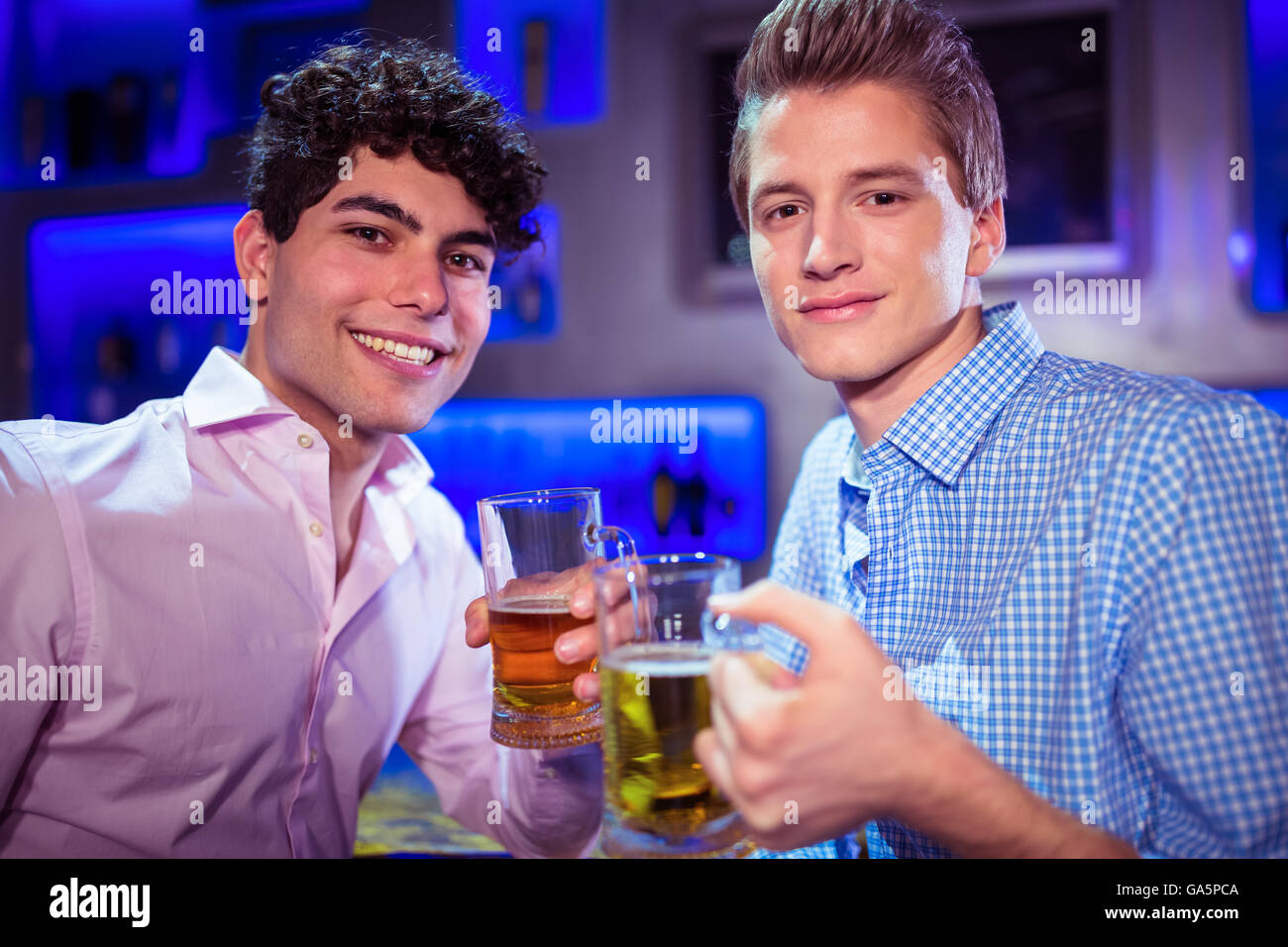 Portrait of smiling friends enjoying alcohol Stock Photo - Alamy