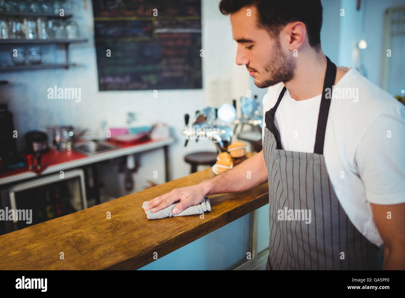 Handsome worker cleaning counter Stock Photo - Alamy