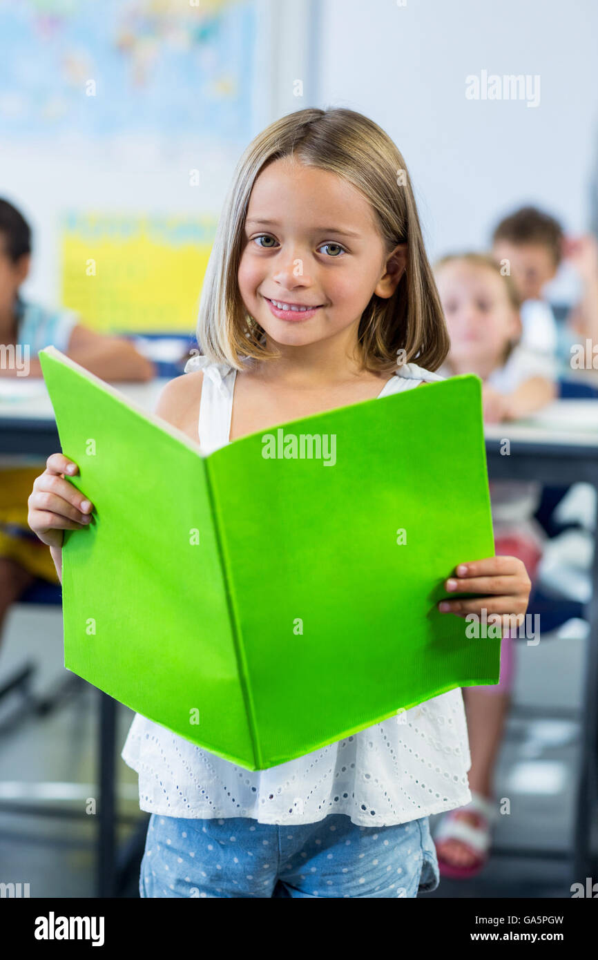 Happy girl reading book Stock Photo - Alamy