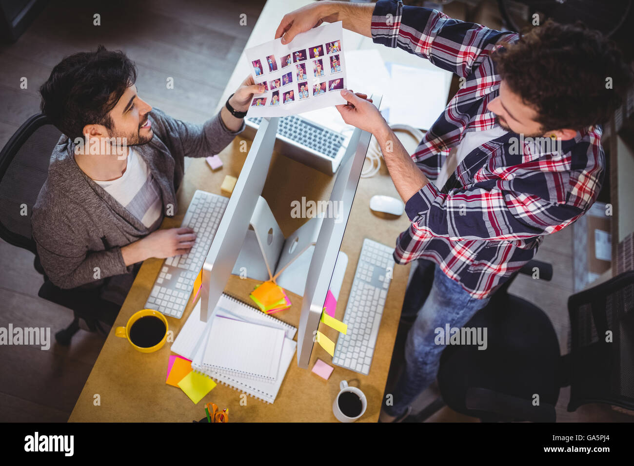Photo editors working at computer desk in creative office Stock Photo ...