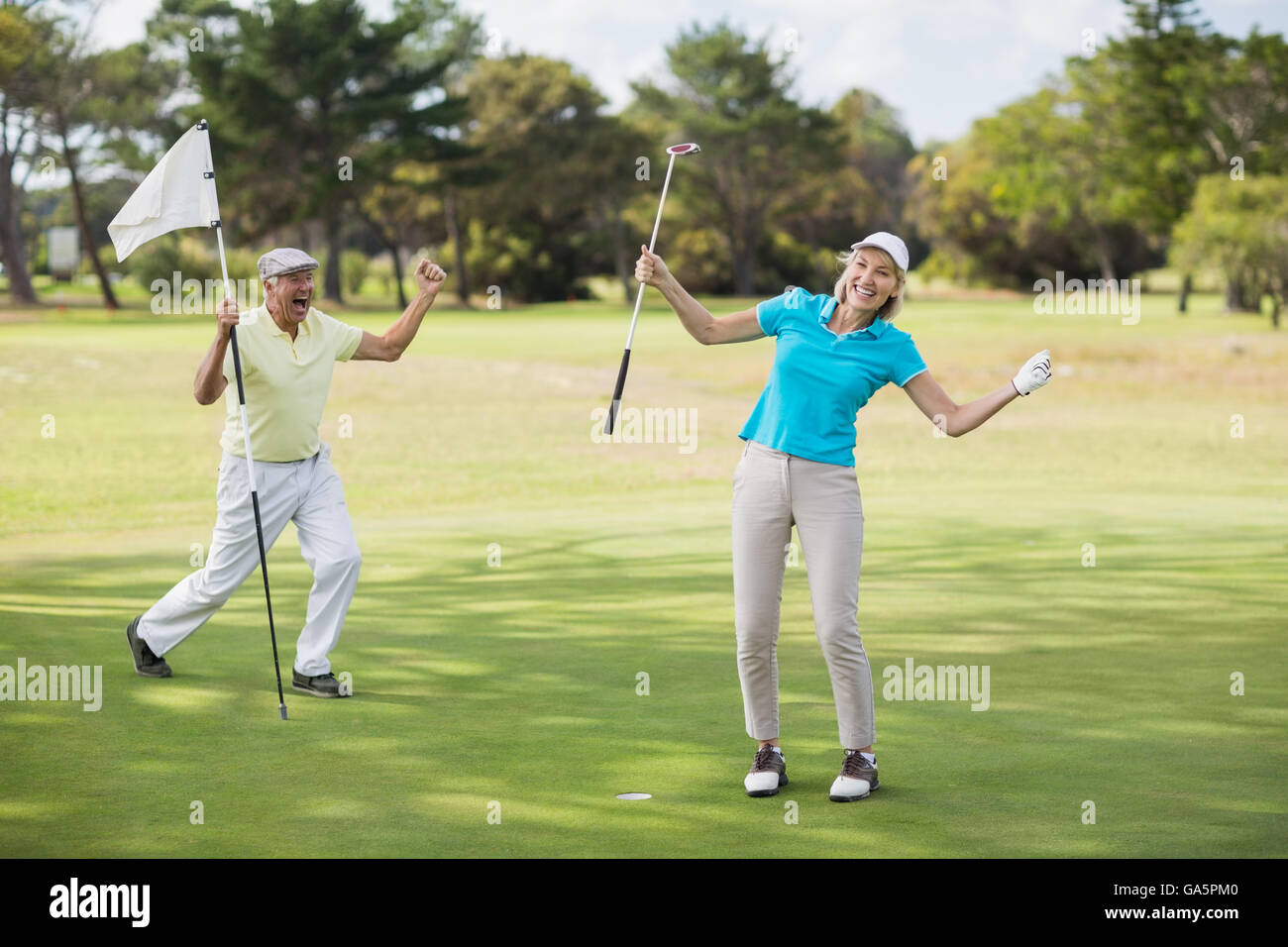 Golfer couple celebrating success Stock Photo - Alamy