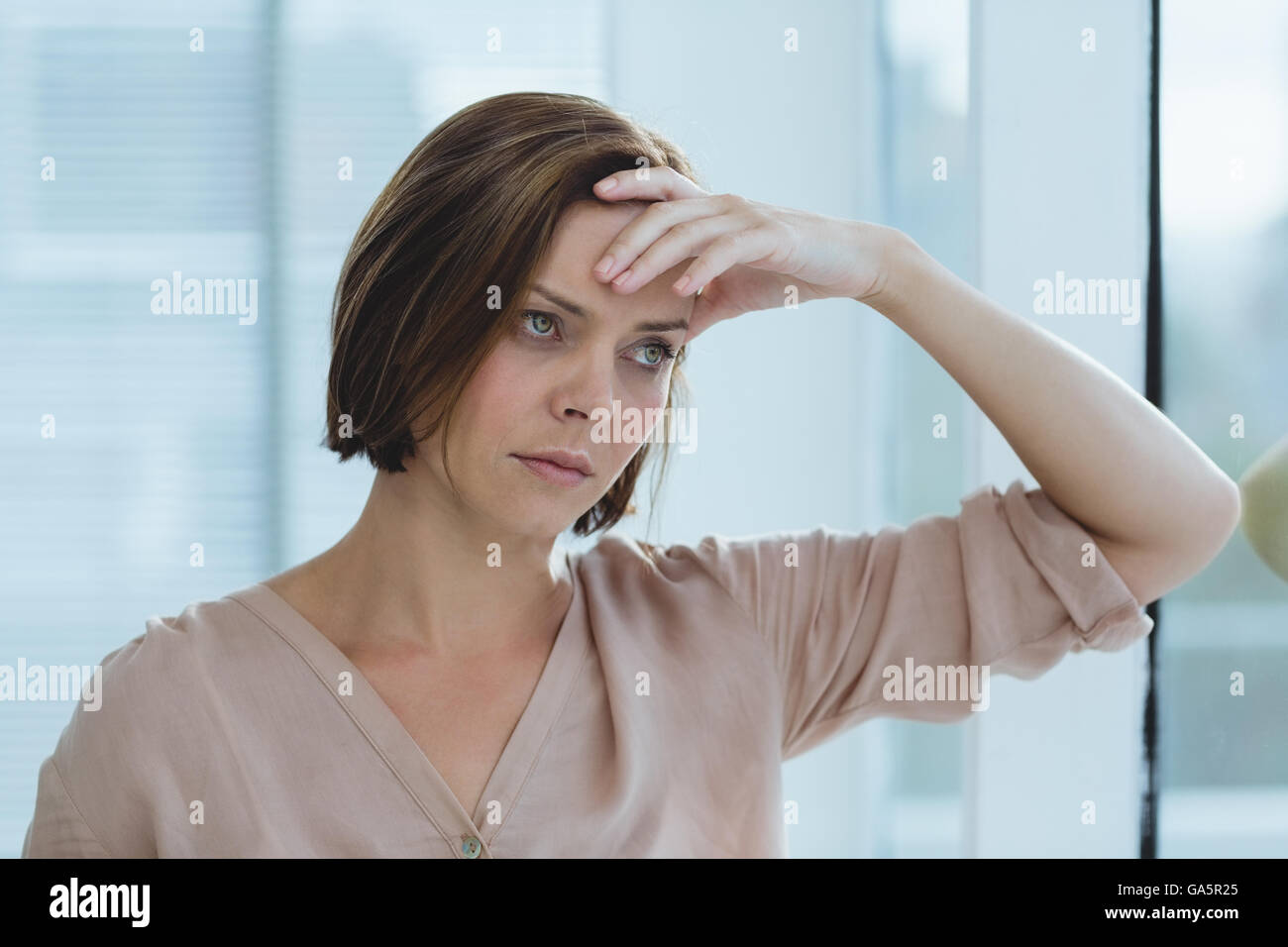 Sad woman standing at home Stock Photo - Alamy