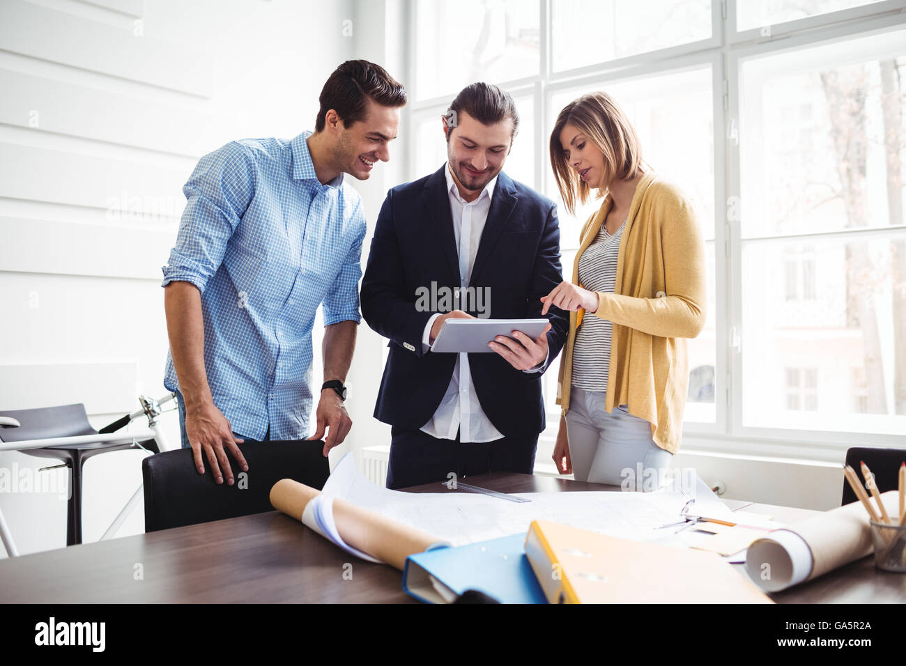 Smiling interior designers using digital tablet Stock Photo - Alamy