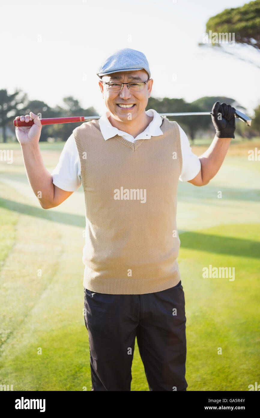 Portrait of golfer smiling and holding his golf club Stock Photo - Alamy