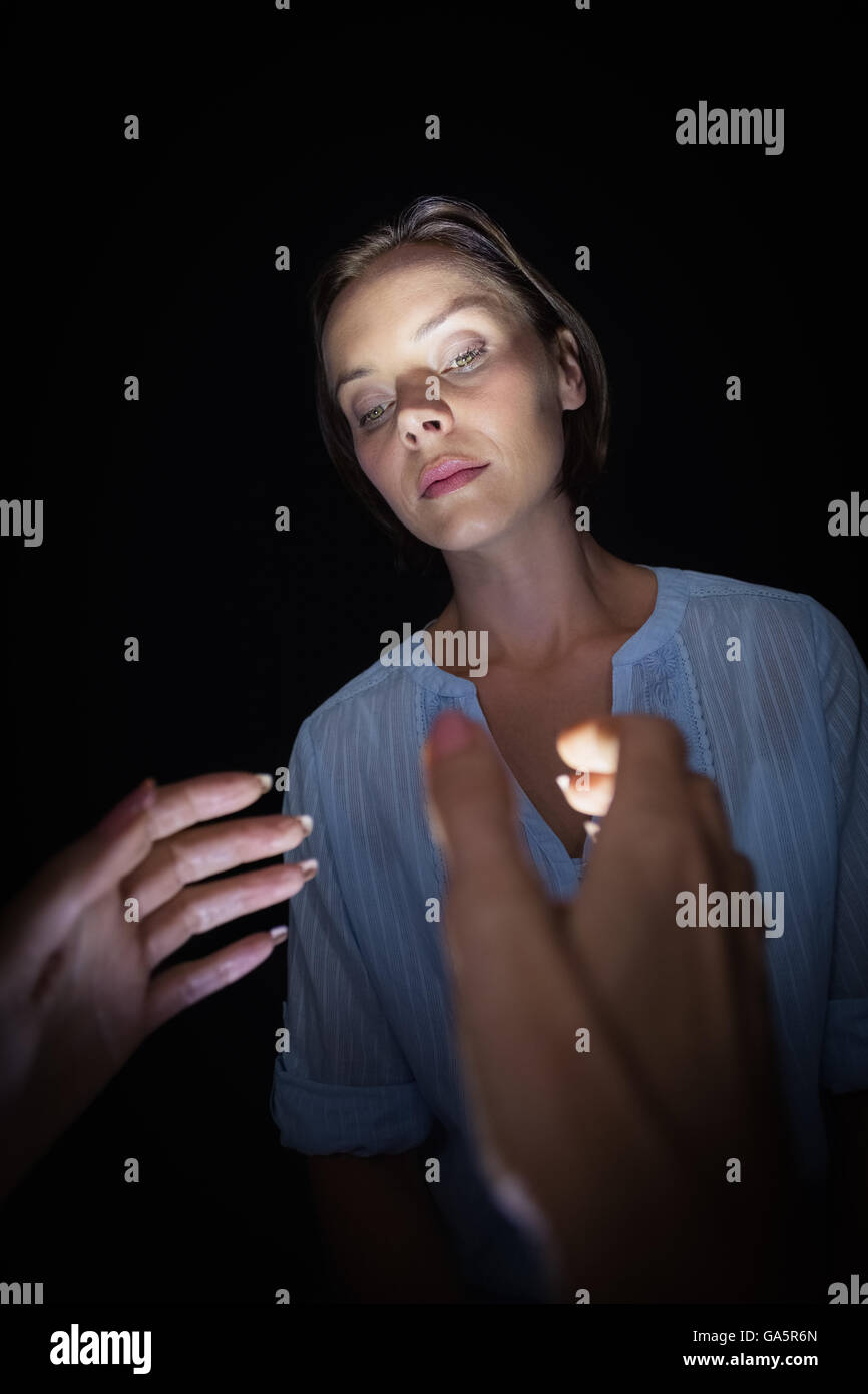 Cropped image of hypnotist hypnotizing woman Stock Photo - Alamy