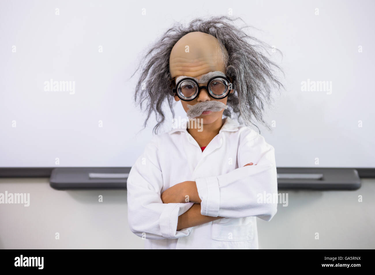 Boy dressed as scientist standing in classroom Stock Photo - Alamy