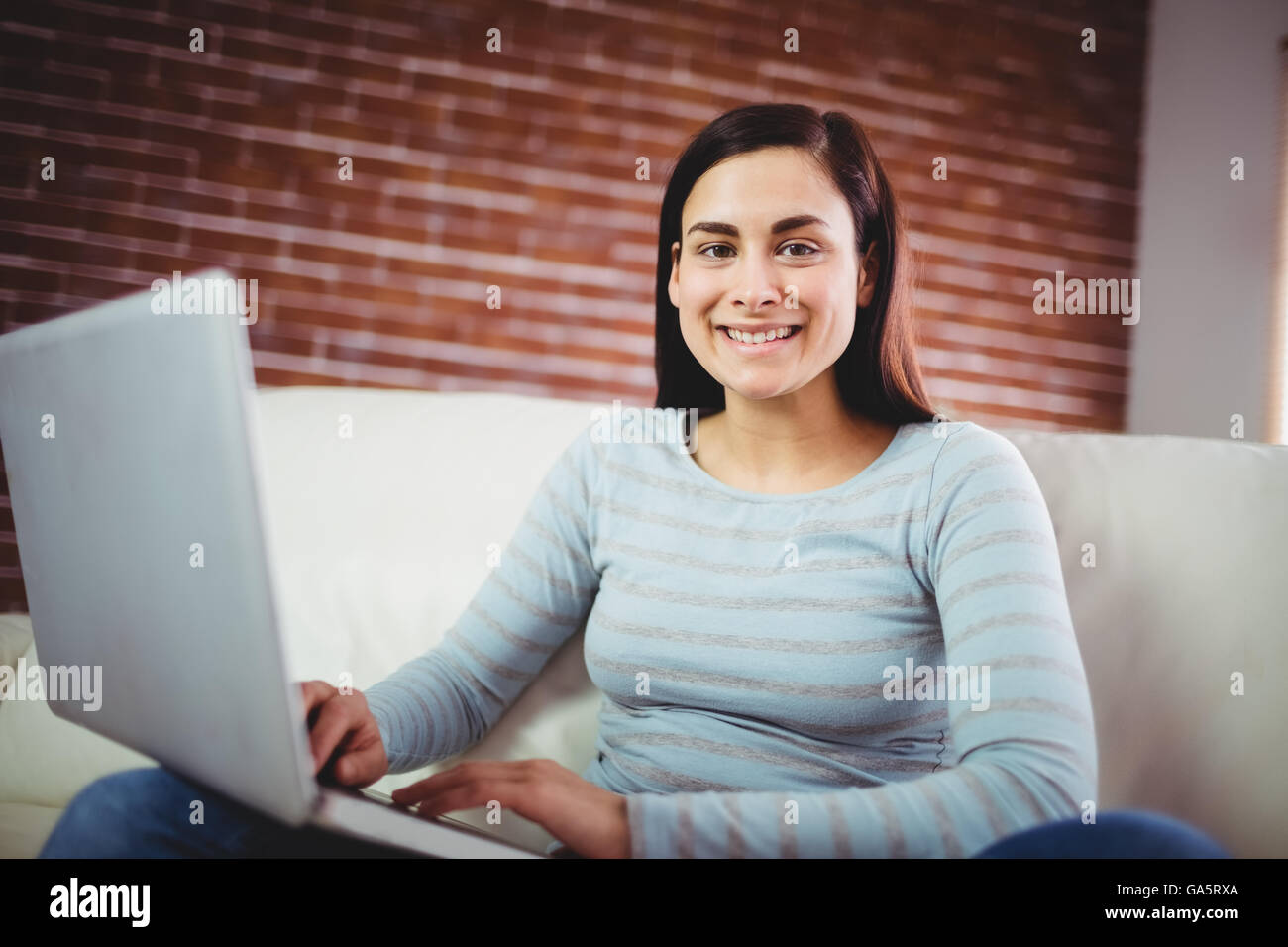 Portrait of smiling woman using laptop Stock Photo - Alamy